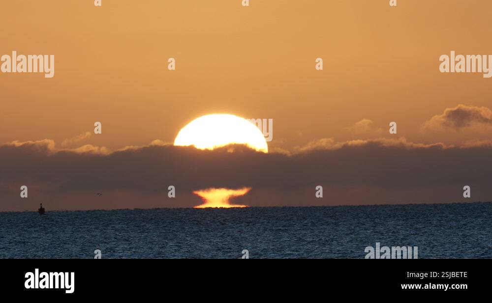 The sun rising at dawn over the North Sea from Beadnell, Northumberland ...