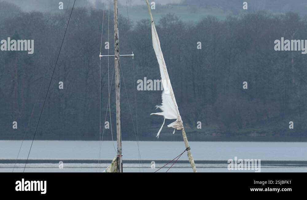 A sailing boat with its sail shredded by storm force winds, Lake ...