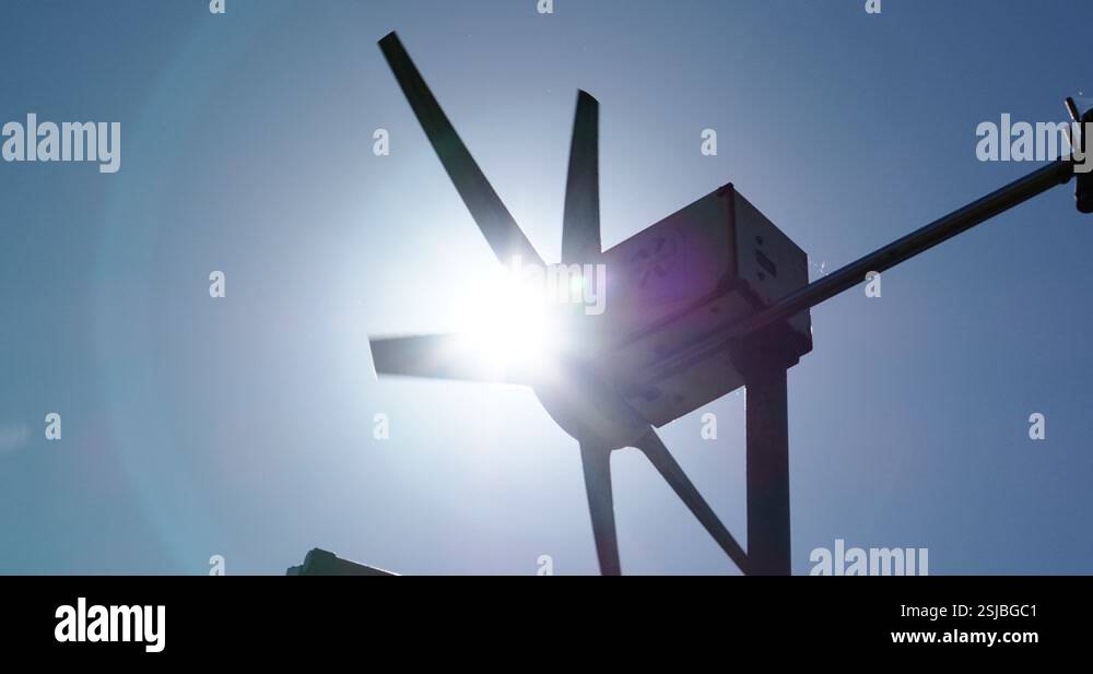 An illuminated road sign powered by a solar panel and wind turbine ...