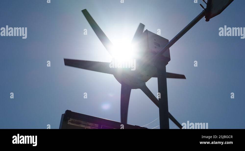 An illuminated road sign powered by a solar panel and wind turbine ...