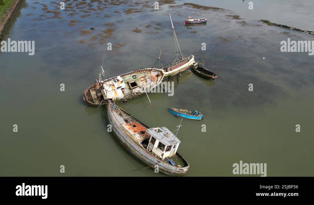 Orbit of derelict shipwrecks in muddy water of the River Wyre at ...