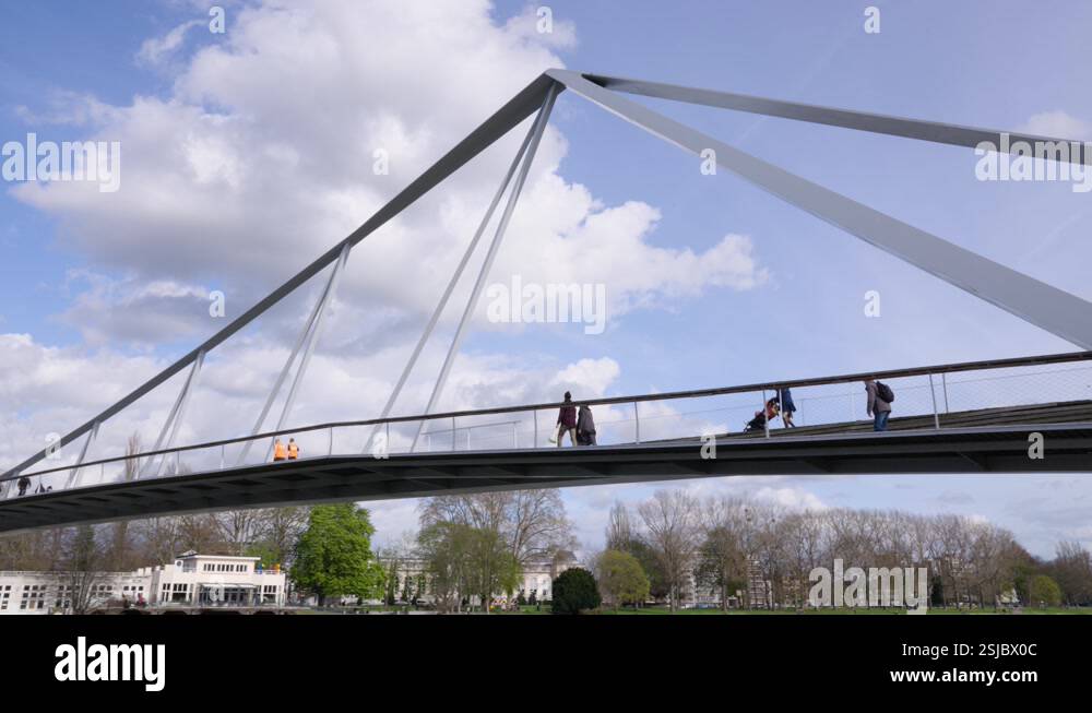 People walking on the Passerelle La Belle Liégeoise. Modern pedestrian ...