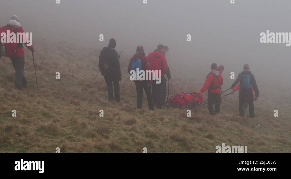 Members of a mountain rescue team stretcher a casualty off a Lake ...