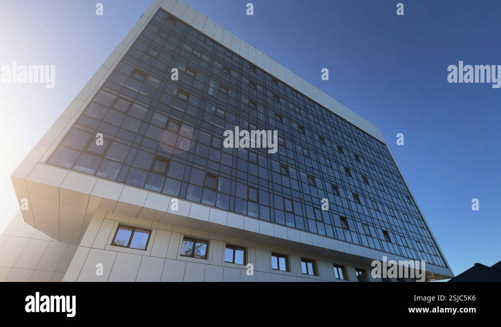 Modern hospital building with a glazed exterior. Bottom up of the ...