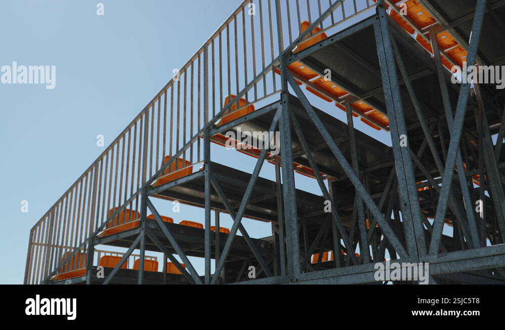 Metal structures of tribune to accommodate rows of plastic yellow seats ...