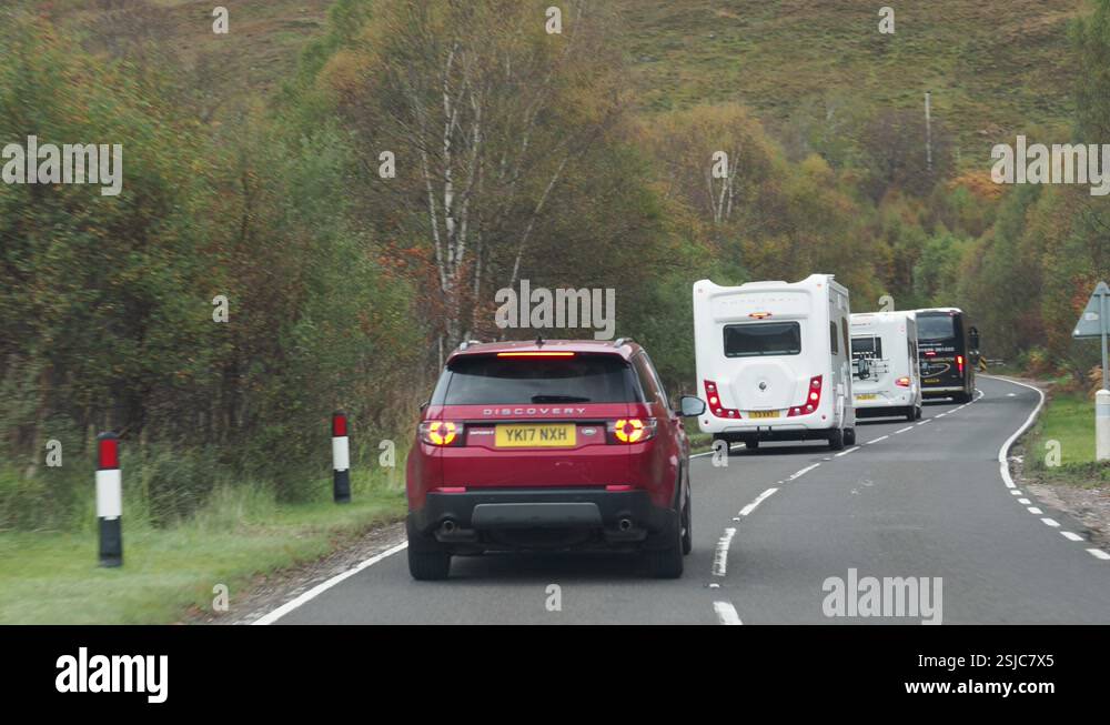 Cars and motorhomes driving along the A87 west of Invergarry, Scotland ...