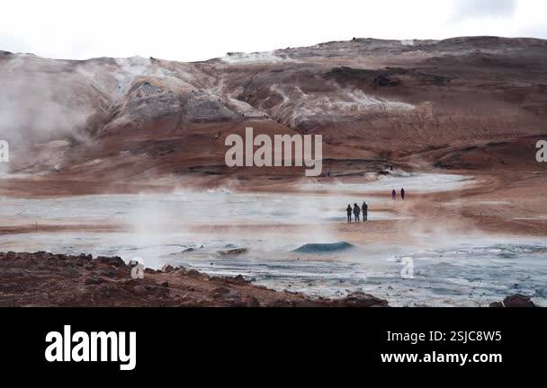 Nmafjall Geothermal Area. Tourists stroll among steaming fumaroles and ...