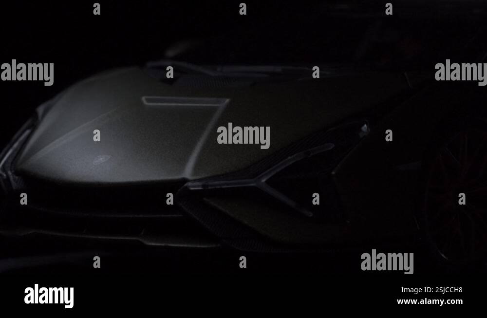 front on shot of a Lamborghini Sian being revealed from the darkness by ...