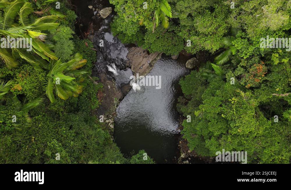 Water cascading down a hidden creek system into a naturally formed ...
