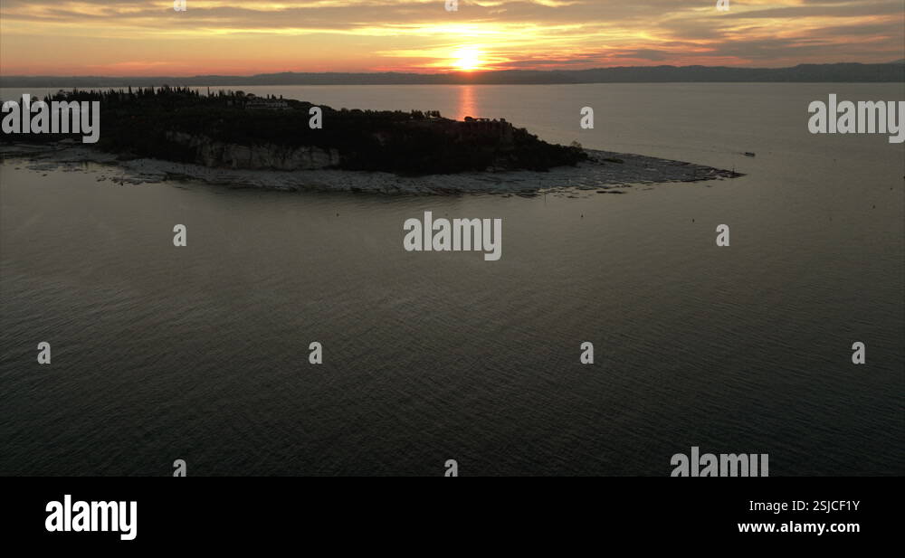 Aerial reveal of strip of land in the middle of Sirmione Lake with ...