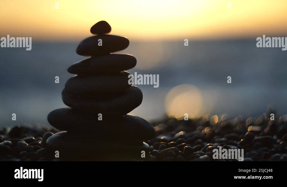 Balanced rock pyramid on pebbles beach, sunny day and clear sky at ...