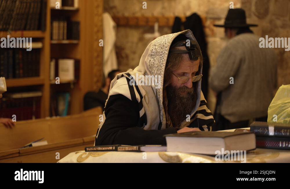Religious Jewish man praying wearing Tefillin, phylacteries, and a ...