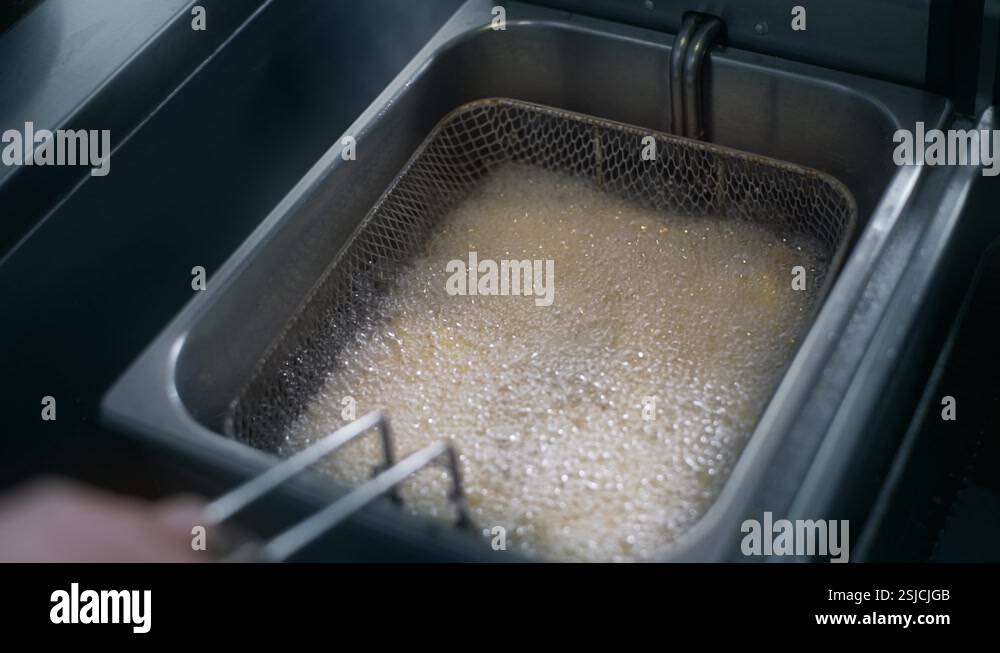 person frying French fries in a snack bar Stock Video Footage - Alamy