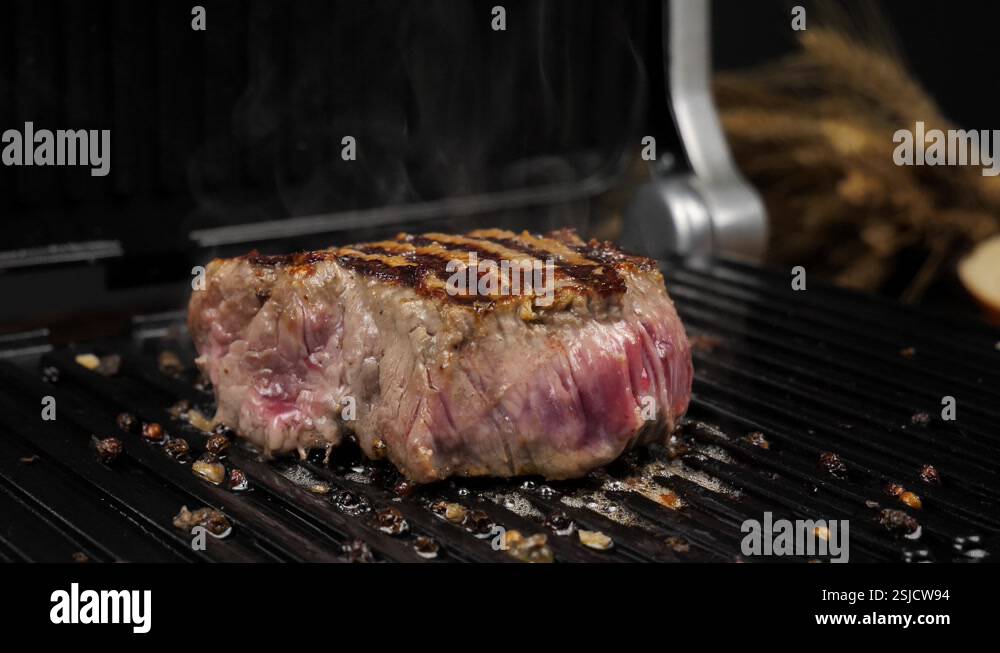Delicious juicy meat steak cooked on the grill. Cooked juicy beef steak ...