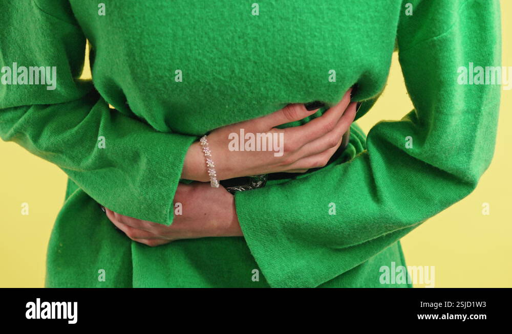 Woman squeezing belly hands because of abdominal pain. Suffering ...