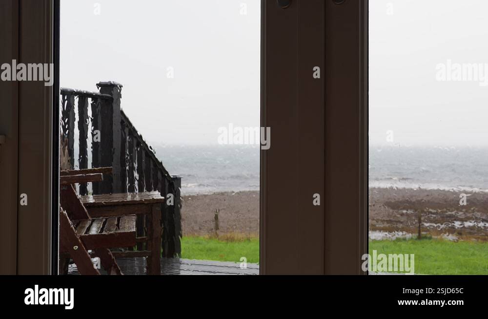 Heavy rain falling on a glass door of a house in Broadford, Isle of ...