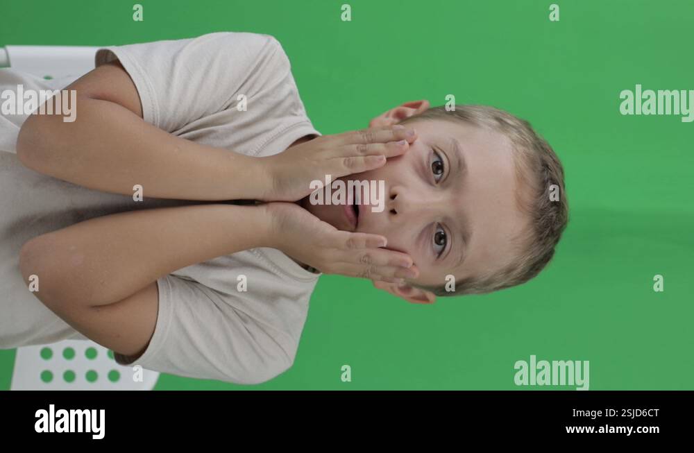 Boy of 9 years behaves very surprised. Green screen.Closeup Stock Video ...