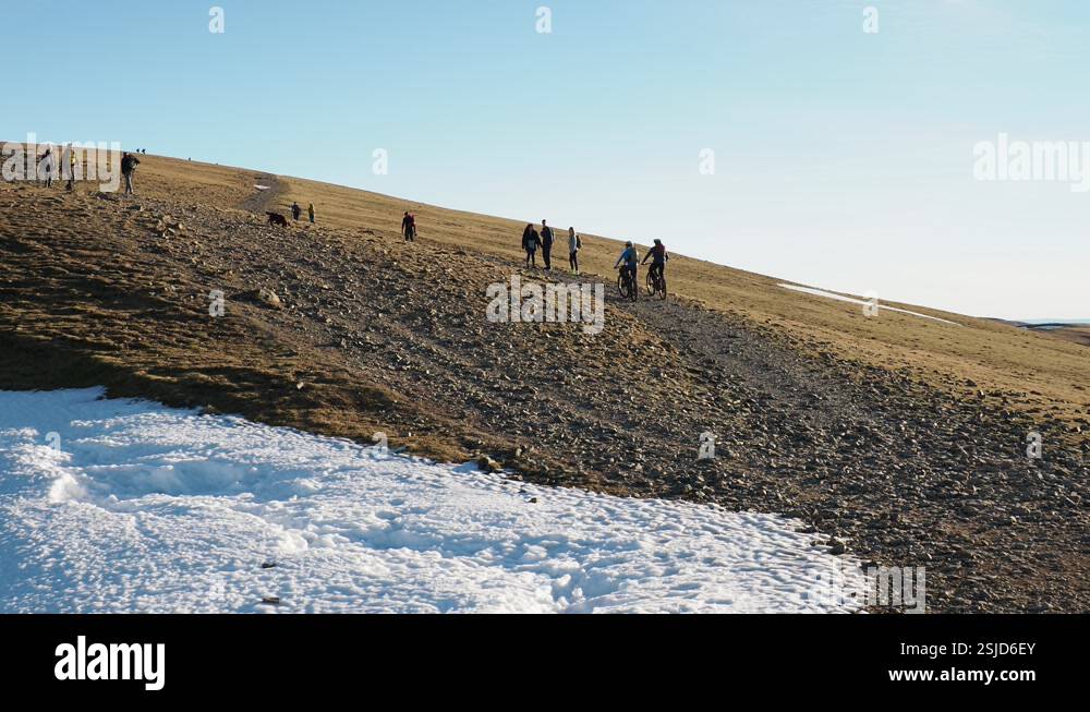 Hikers and mountain bikers approaching the summit of Helvellyn, Lake ...