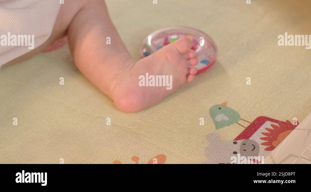 Close-up child little girl foot on floor in play. Foot tickling reflex ...
