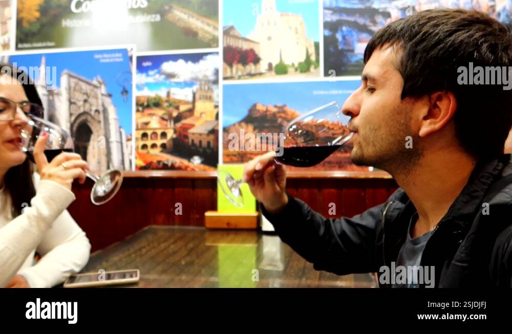 Caucasian couple toasting in restaurant with glass of wine. Handheld ...