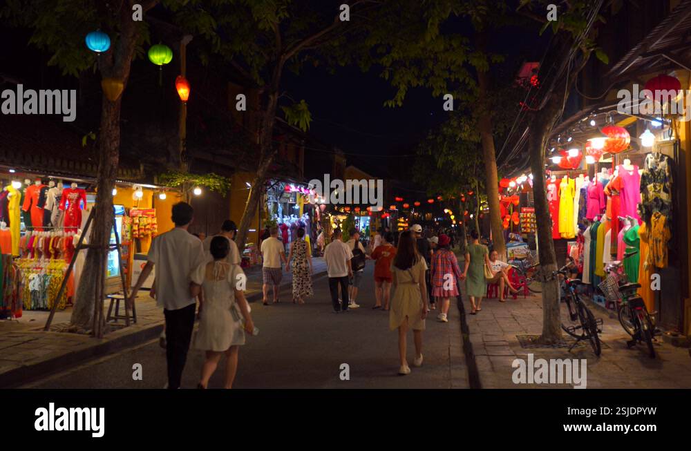 Typical night time scenery in Vietnam with illuminated street stalls ...