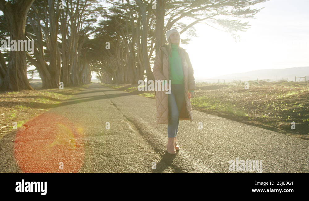 Nice female on hiking adventure 4K at scenic golden misty sunrise lens ...