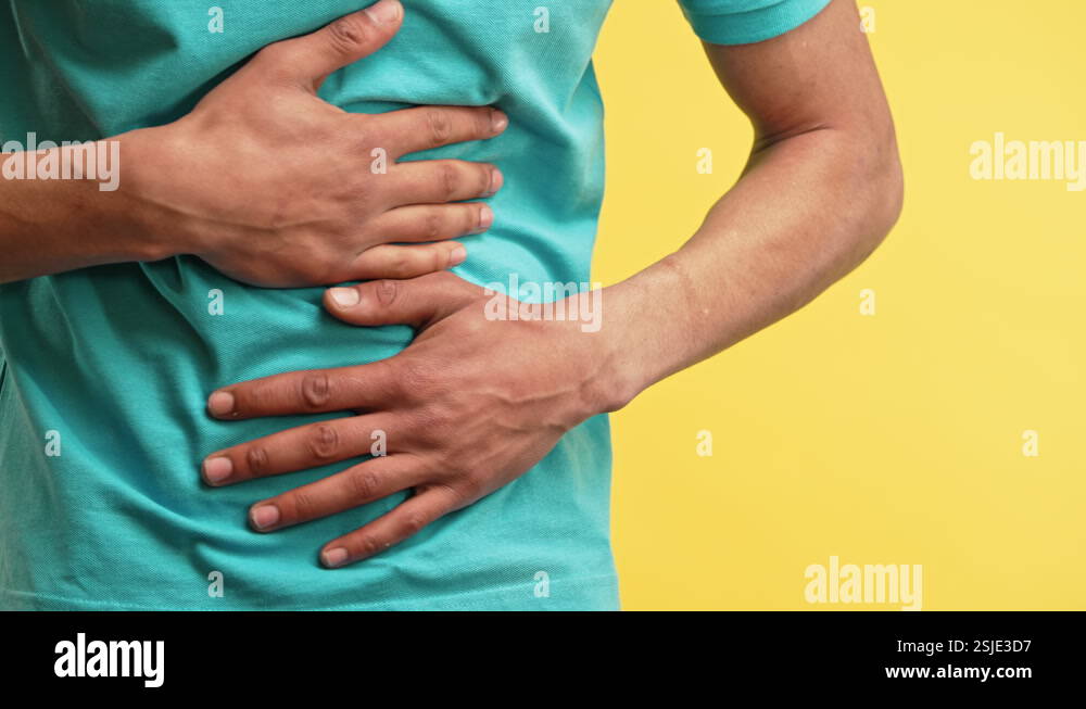 Man squeezing belly hands because of abdominal pain. Suffering stomach ...