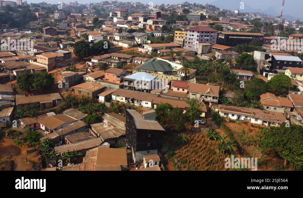 Drone shot over suburban streets and homes of Yaounde, sunny Cameroon ...