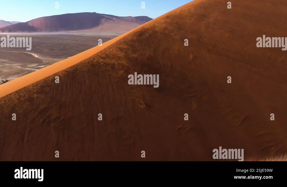 Wind dusting sand dunes in the Namib desert, golden hour in Namibia ...
