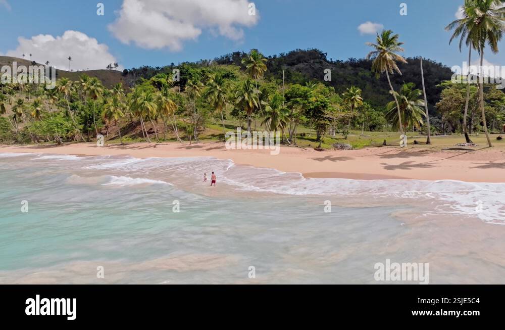 Couple in sea waters of Playa Colorada beach, Las Galeras in Dominican ...