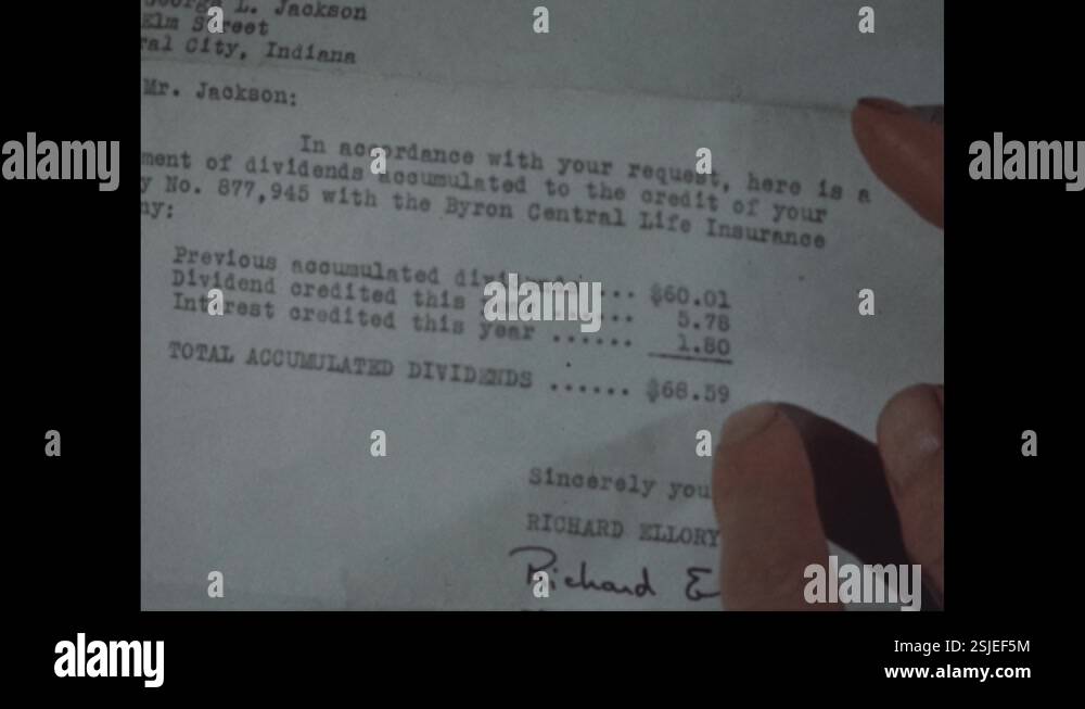 1950s: Finger points to typed letter, sum of dividends. Living room ...