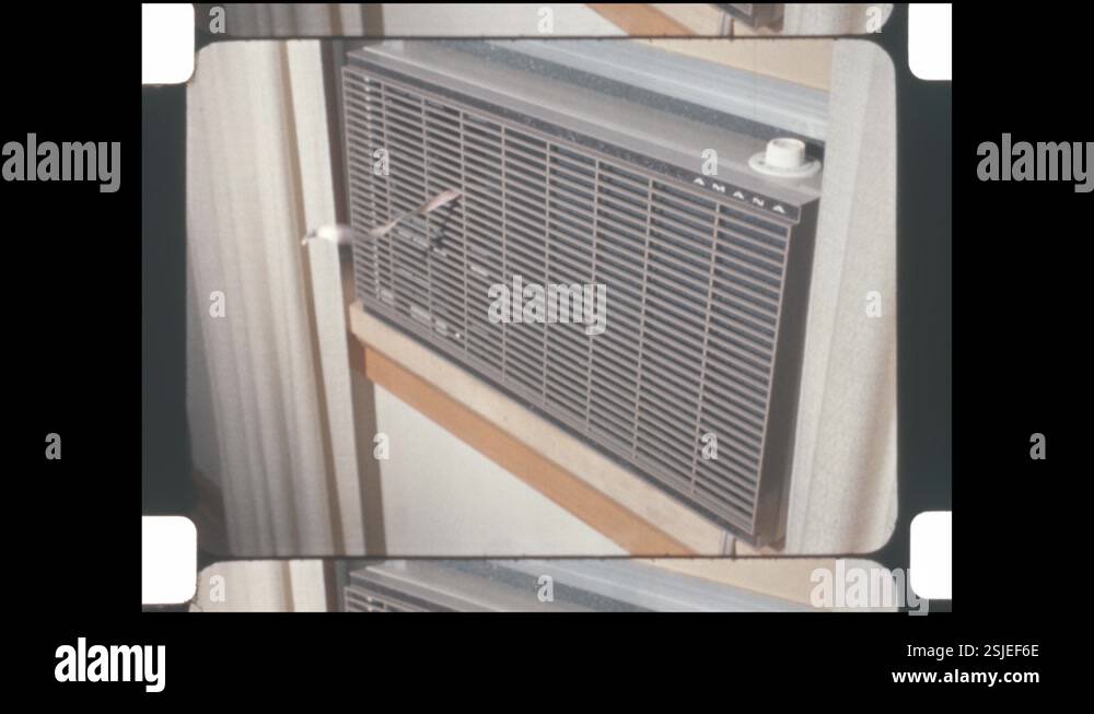 1960s: Back of air-conditioning window unit with curtains. Clapperboard ...