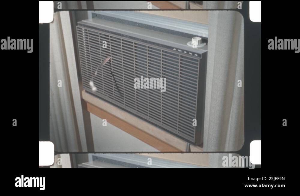 1960s: Clapperboard. Piece of ribbon blows out of air-conditioner grate ...