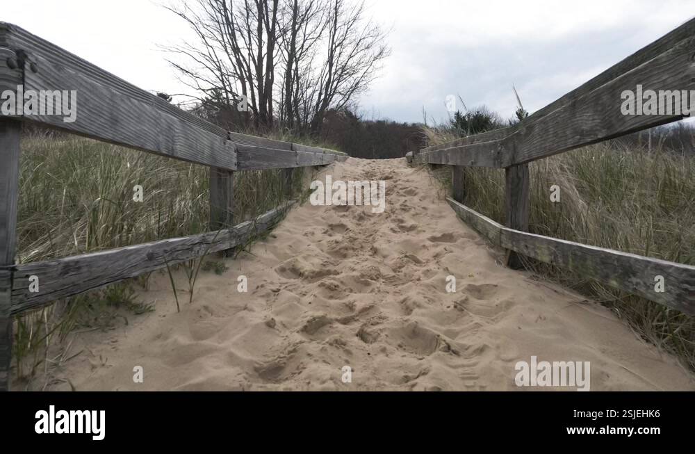 Sand mound blocking the old boardwalk path Stock Video Footage - Alamy