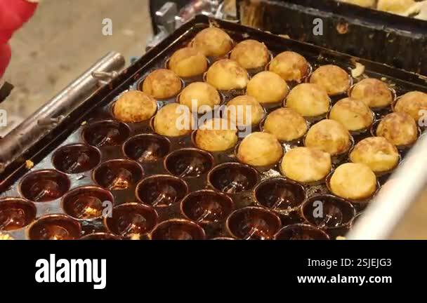 Japanese Takoyaki cooking. A street food chef preparing freshly cooked ...
