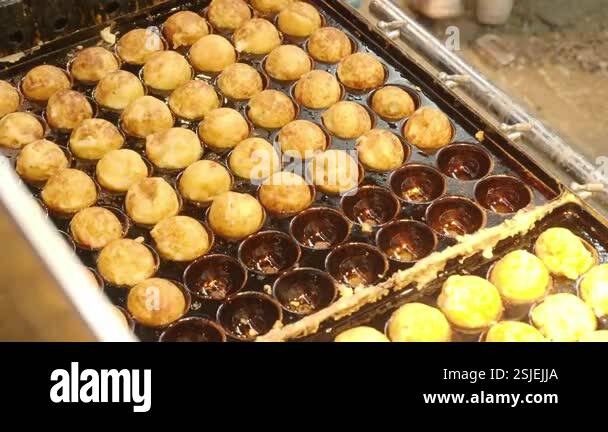 Japanese Takoyaki cooking. A street food chef preparing freshly cooked ...