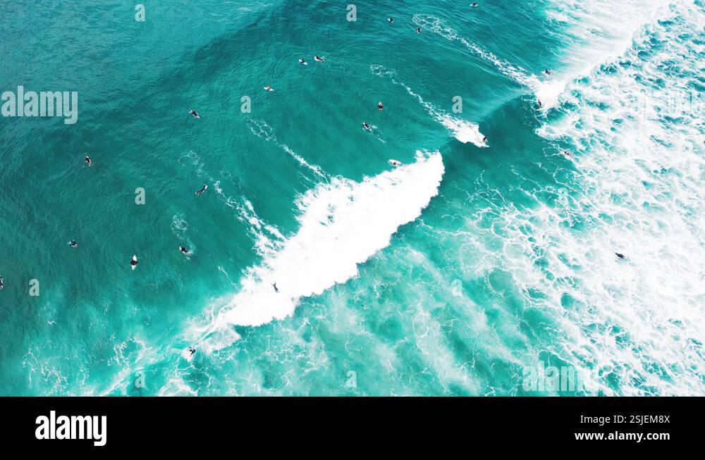 Surfing aerial. Surfers wait waves on line up and paddle around Stock ...