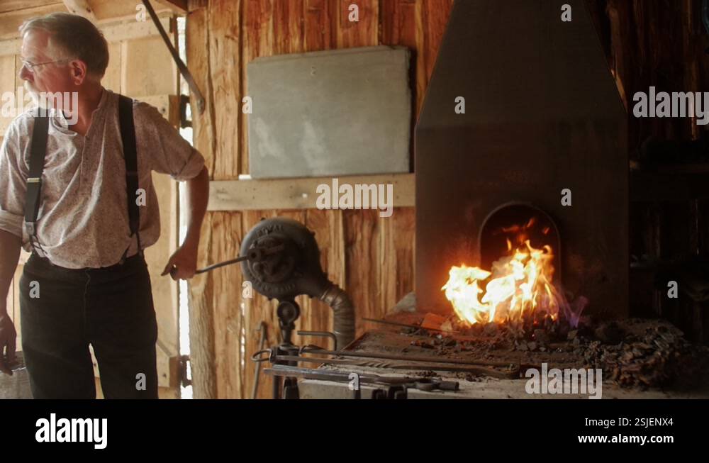 A blacksmith reenactor brings history to life by portraying a ...