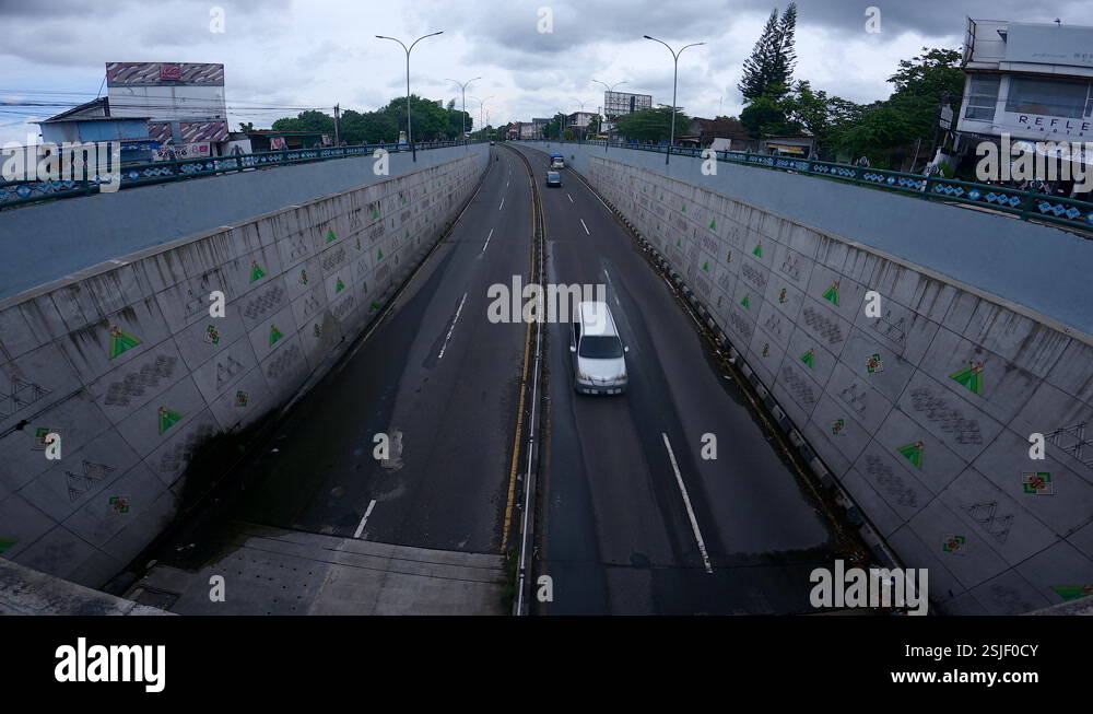 Traffic underpass road down view with four lanes from tilting up camera ...