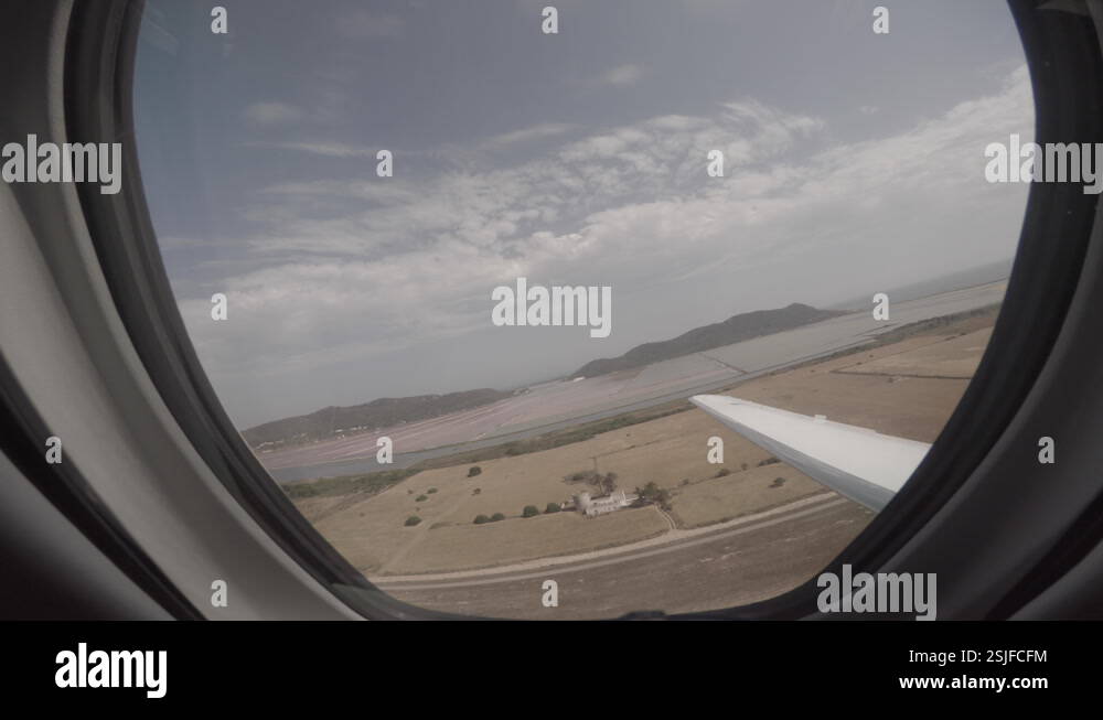 Fixed shot filming outside the window of a private jet flying from ...