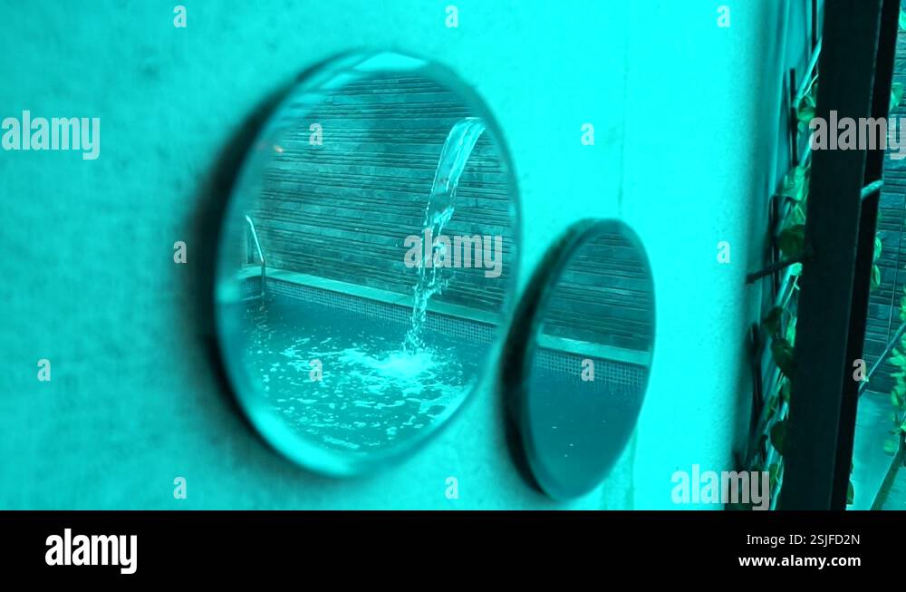 Reflection On Round Mirror Of Water Flowing Out Of Wall Faucet Into ...