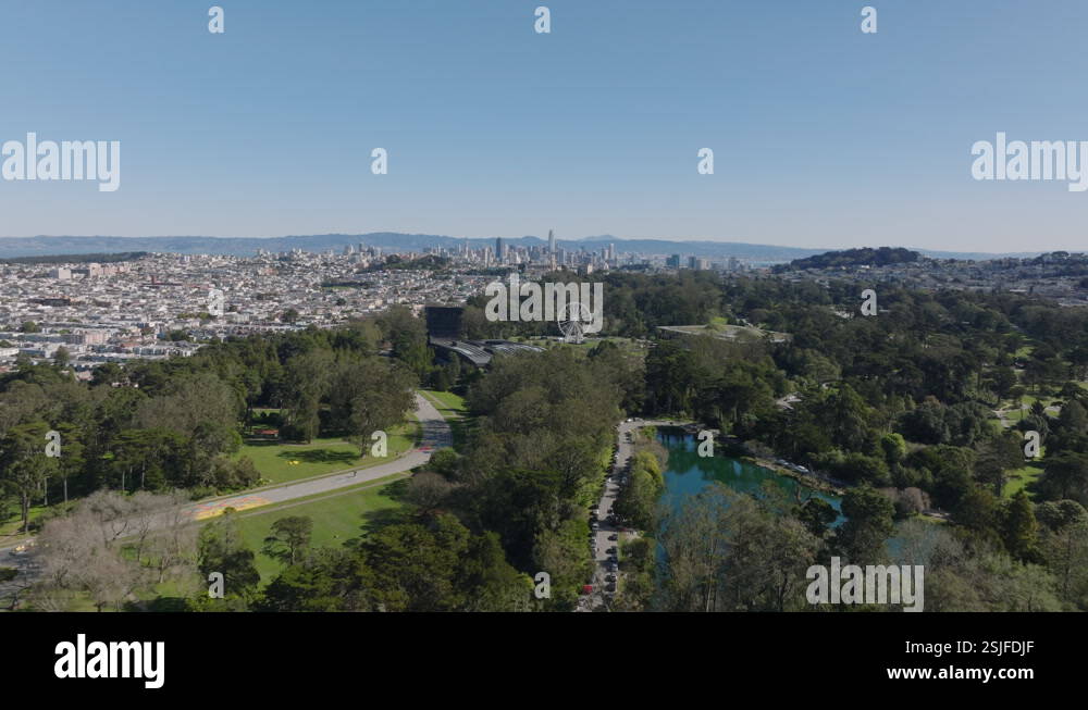 Forwards fly above large urban park in metropolis. Golden Gate Park ...