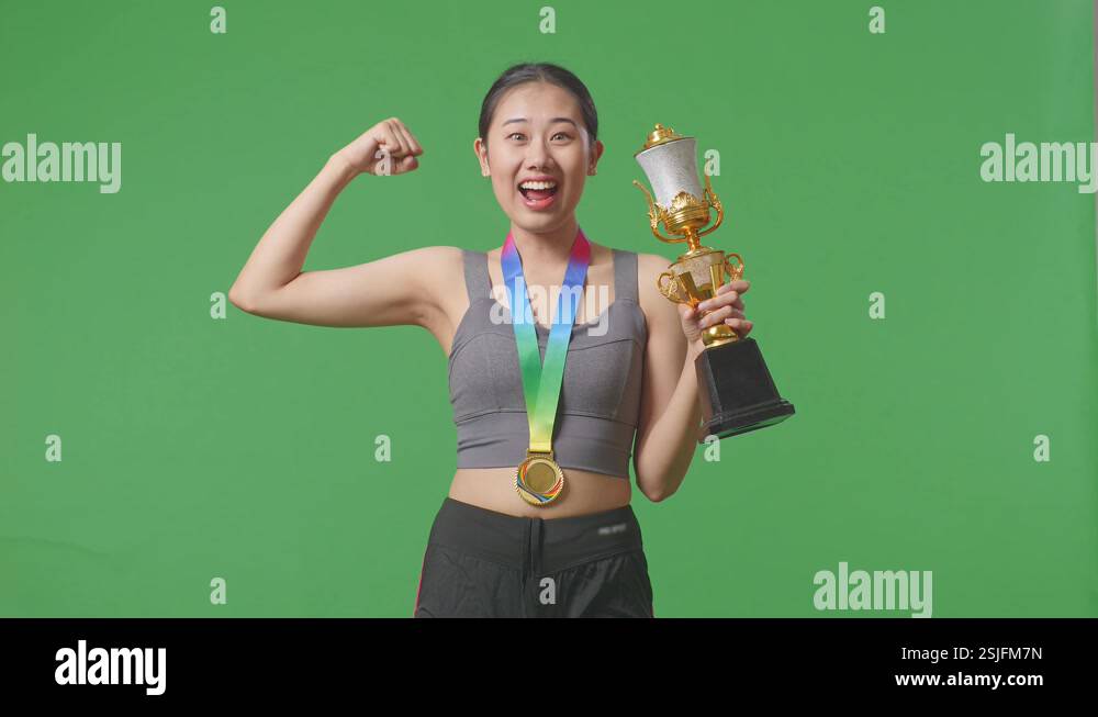 Asian Woman With A Gold Medal And Trophy Flexing Her Bicep And Smiling ...