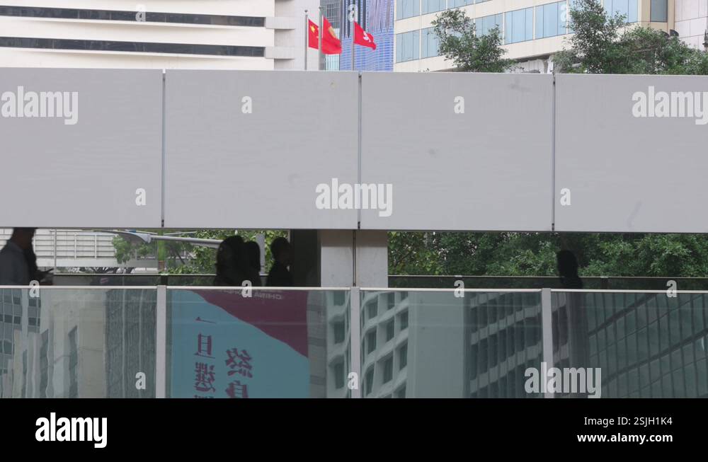 Chinese pedestrians walk through a pedestrian bridge as the People's ...