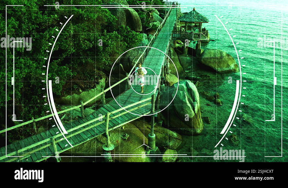 Drone target screen tracking man running on boardwalk along sea cliffs ...