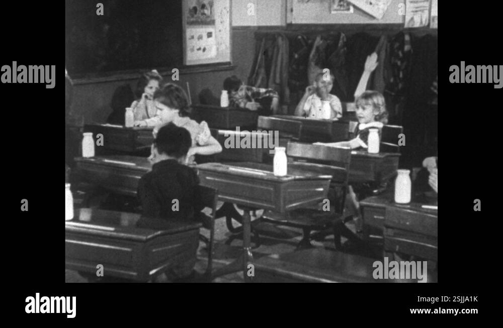 1950s: Boys pass out milk and students say Thank You. Children raise ...