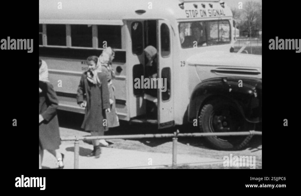 1950s: Children exiting the school bus. Girl explaining her map to the ...