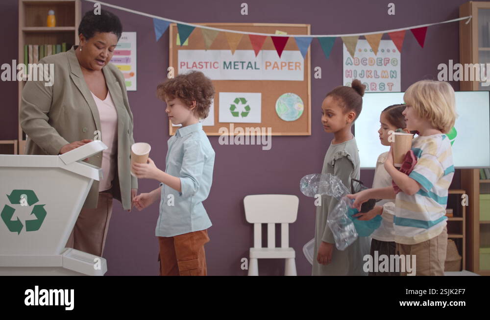 School Kids Sorting Garbage into Containers at School Stock Video ...