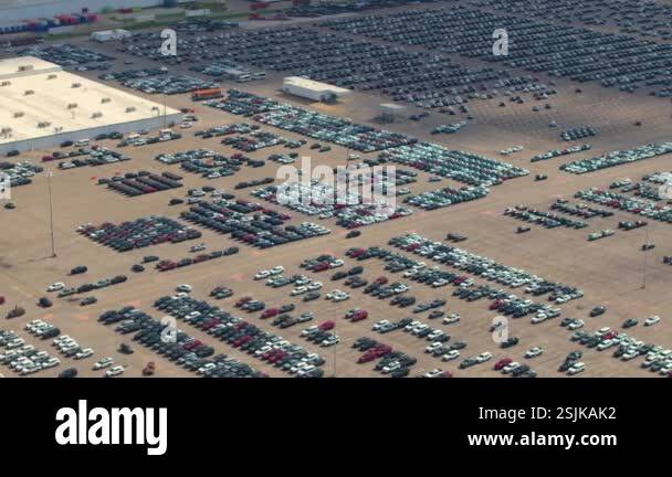 New cars stock at production factory parking lot. Vehicles parked in a ...