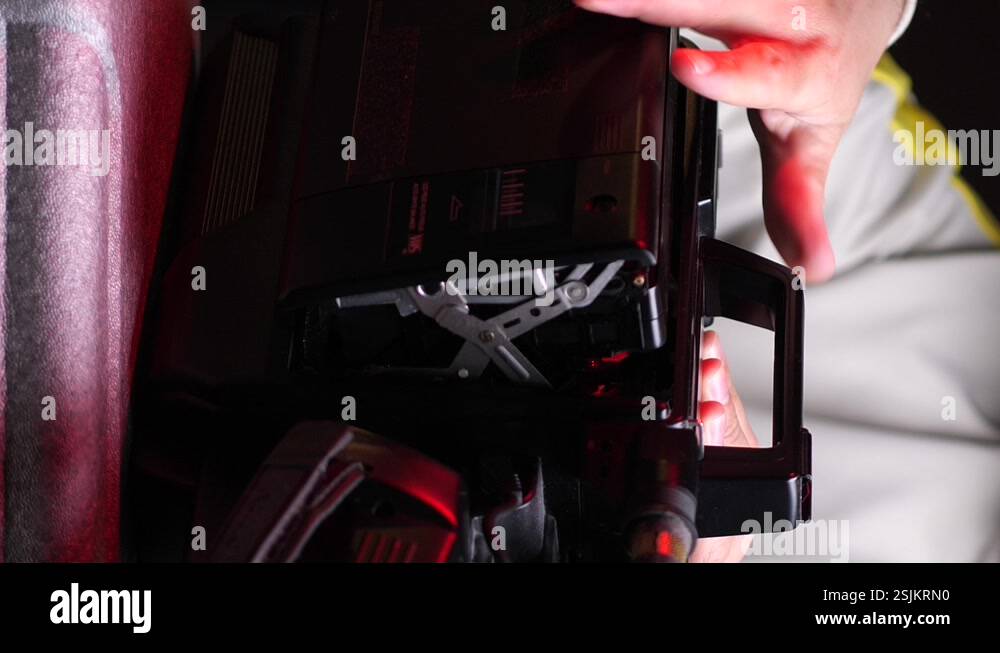 vertical video man inserting vhs cassette into old vintage vhs ...